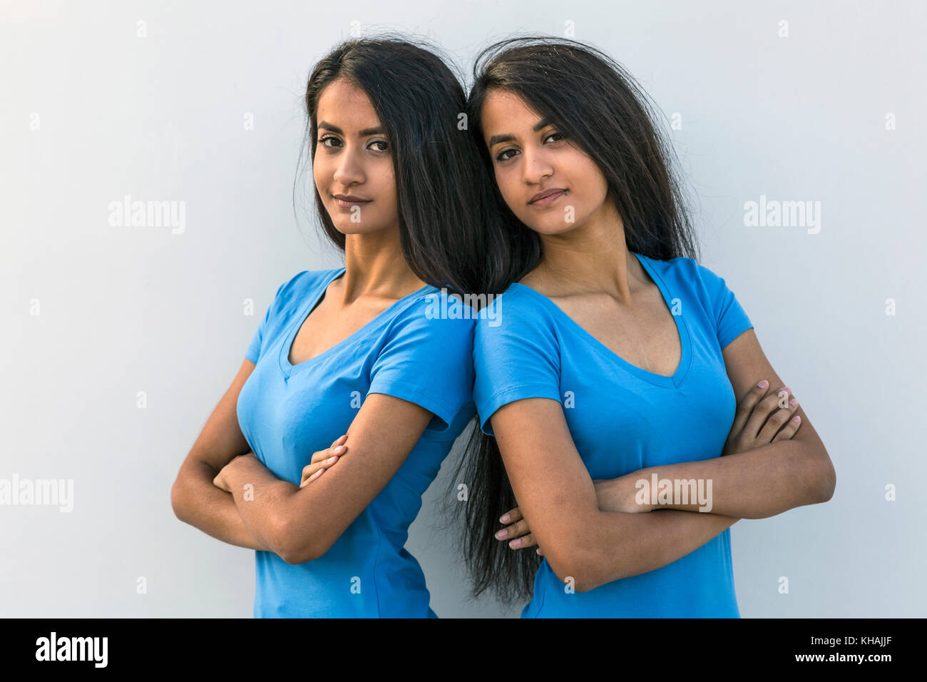 Twins pair backs to backs, shot in summer Stock Photo - Alamy