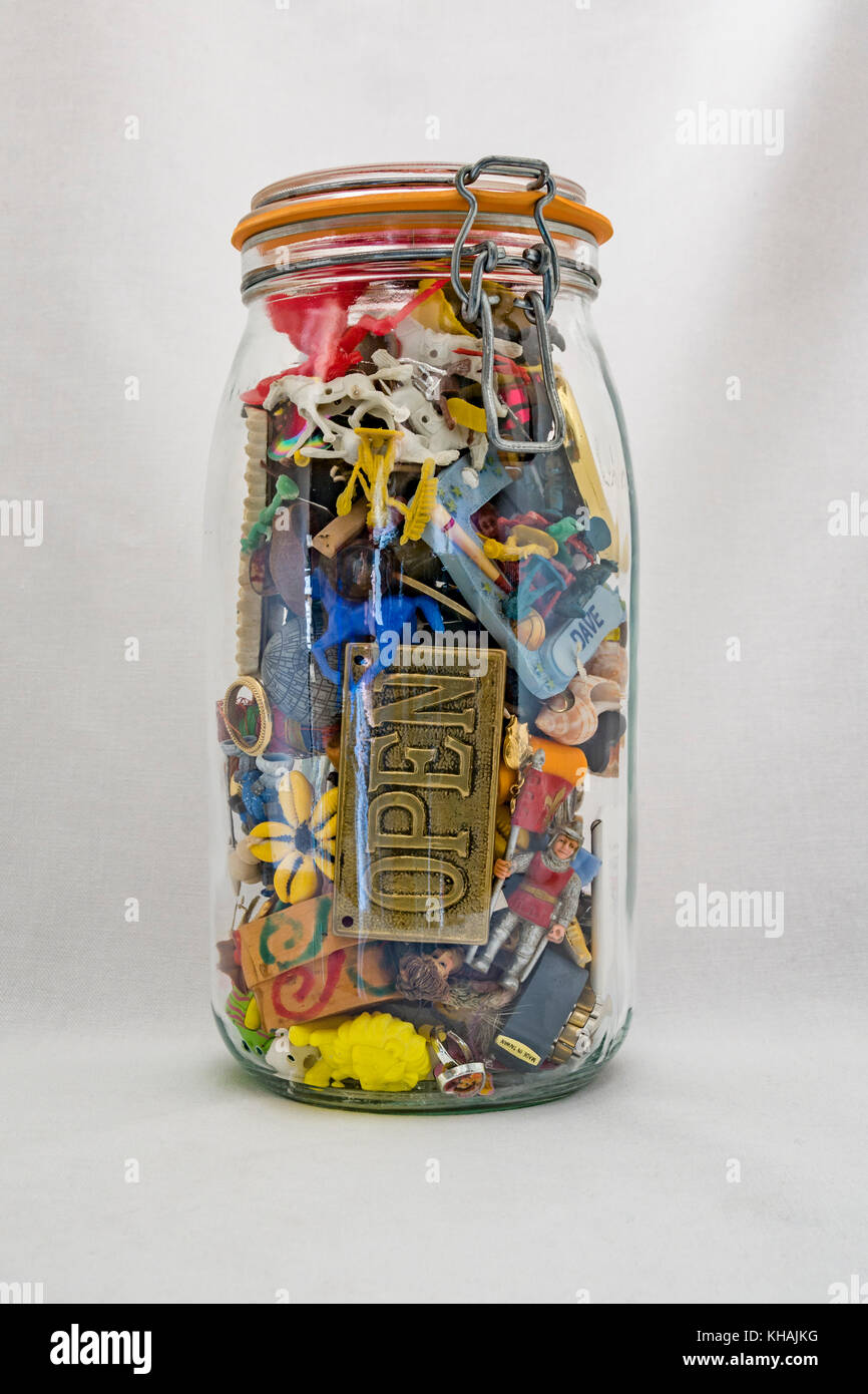 Glass jar of small miscellaneous collectibles Stock Photo - Alamy