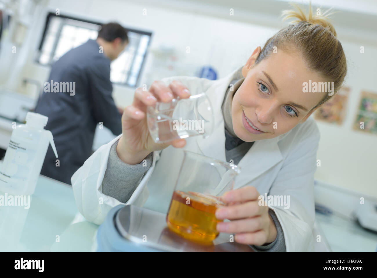 female lab worker holding flask Stock Photo - Alamy