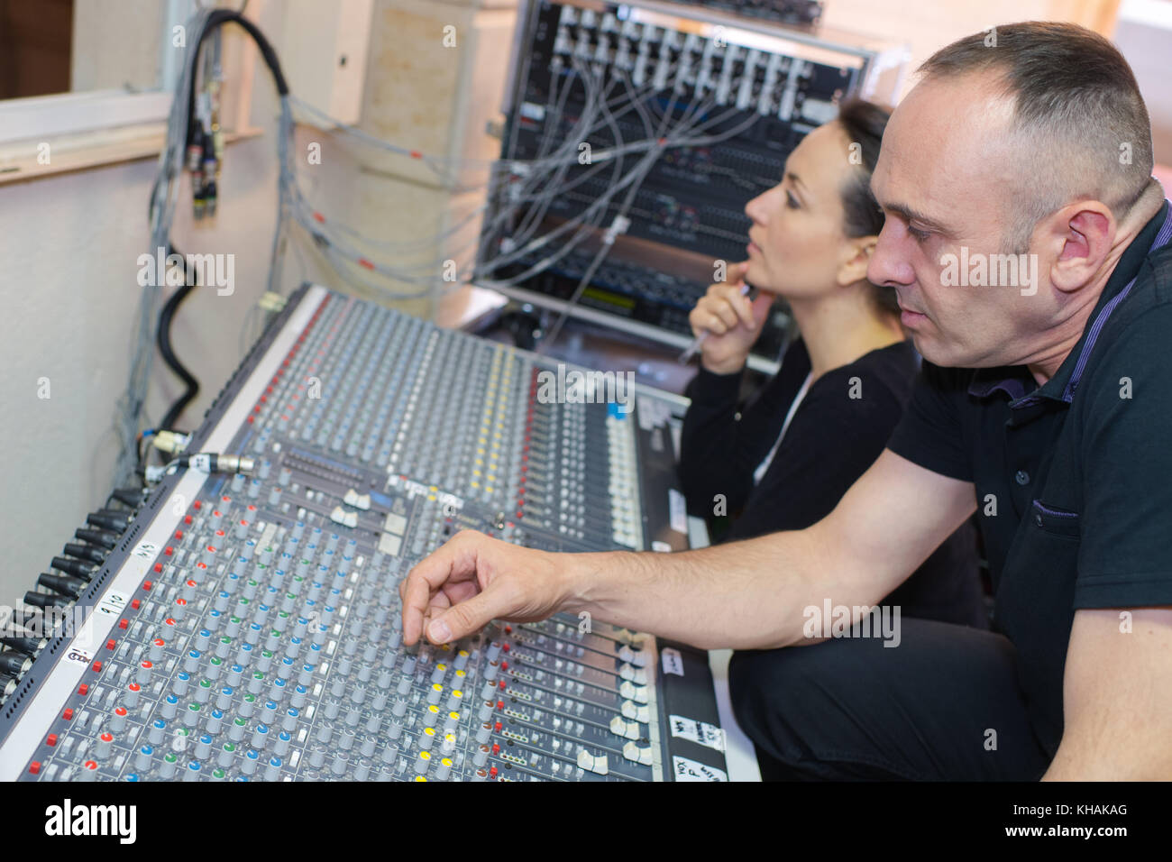 sound engineers working at mixing panel in recording studio Stock Photo ...