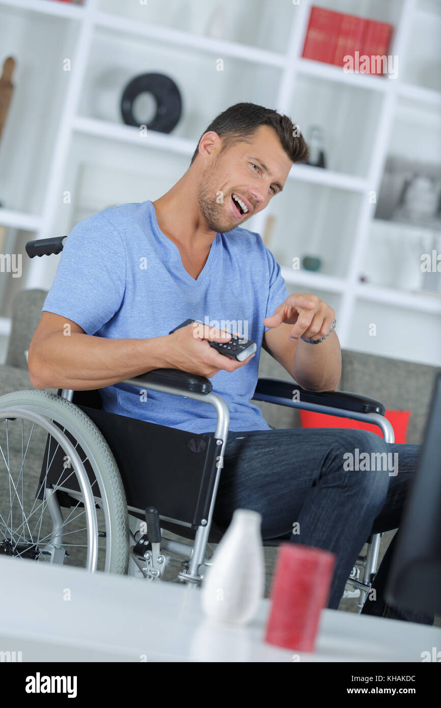 happy disabled man watching tv Stock Photo - Alamy