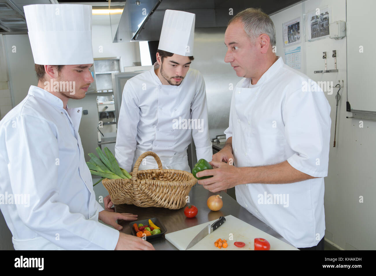 Chef with apprentices teaching about vegetables Stock Photo - Alamy