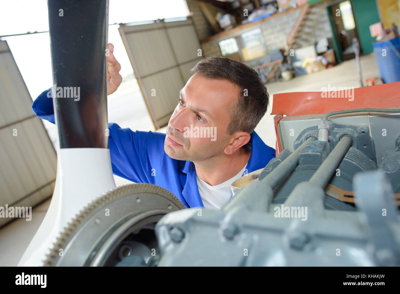 Mechanic inspecting aircraft propellor Stock Photo - Alamy