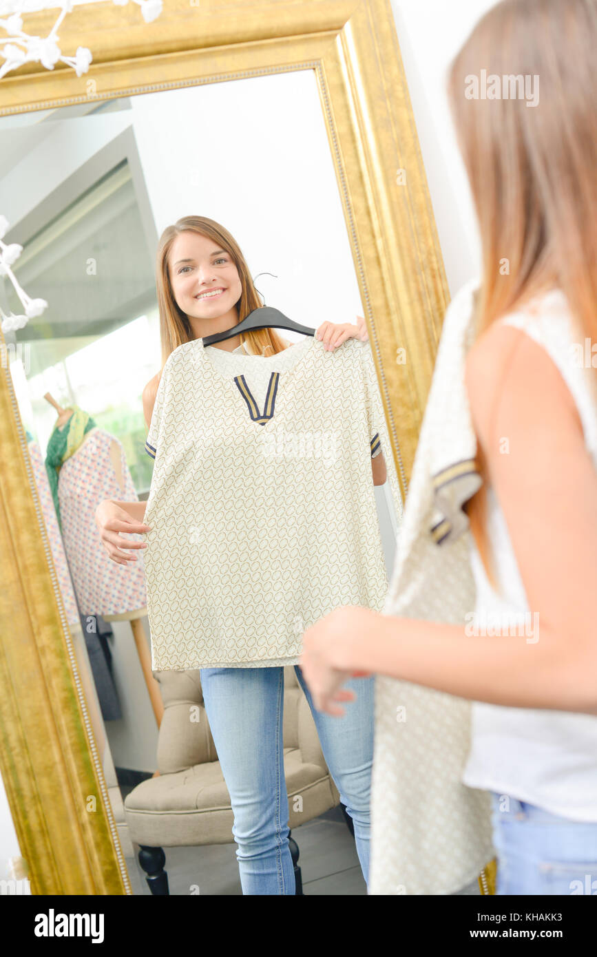 Young woman trying on clothes Stock Photo - Alamy