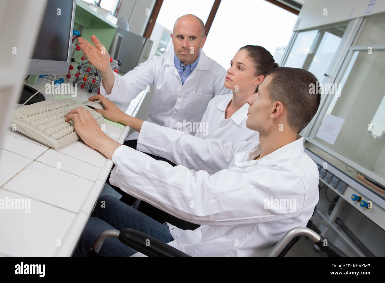 male teacher with teenage students experimenting in lab Stock Photo - Alamy
