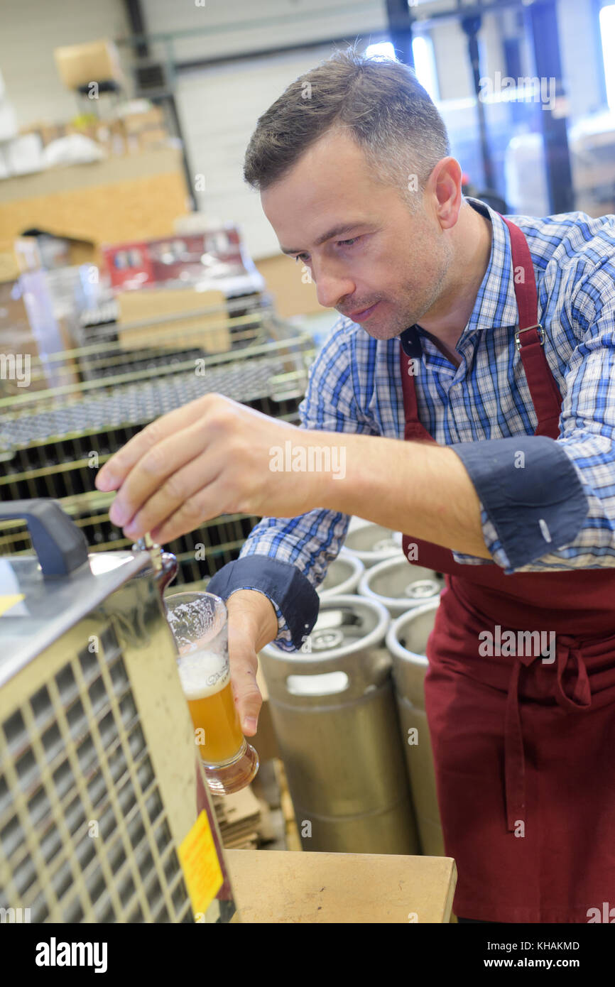 brewery worker with bottling machinery on factory Stock Photo - Alamy