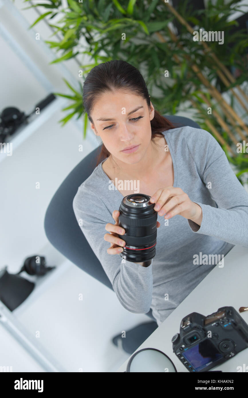 female photographer checking lens Stock Photo - Alamy
