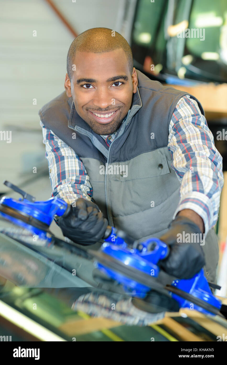 Man fitting new windscreen in vehicle Stock Photo - Alamy