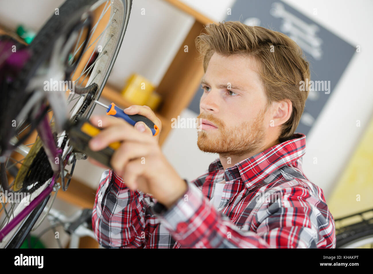 young man repairing his bike Stock Photo - Alamy