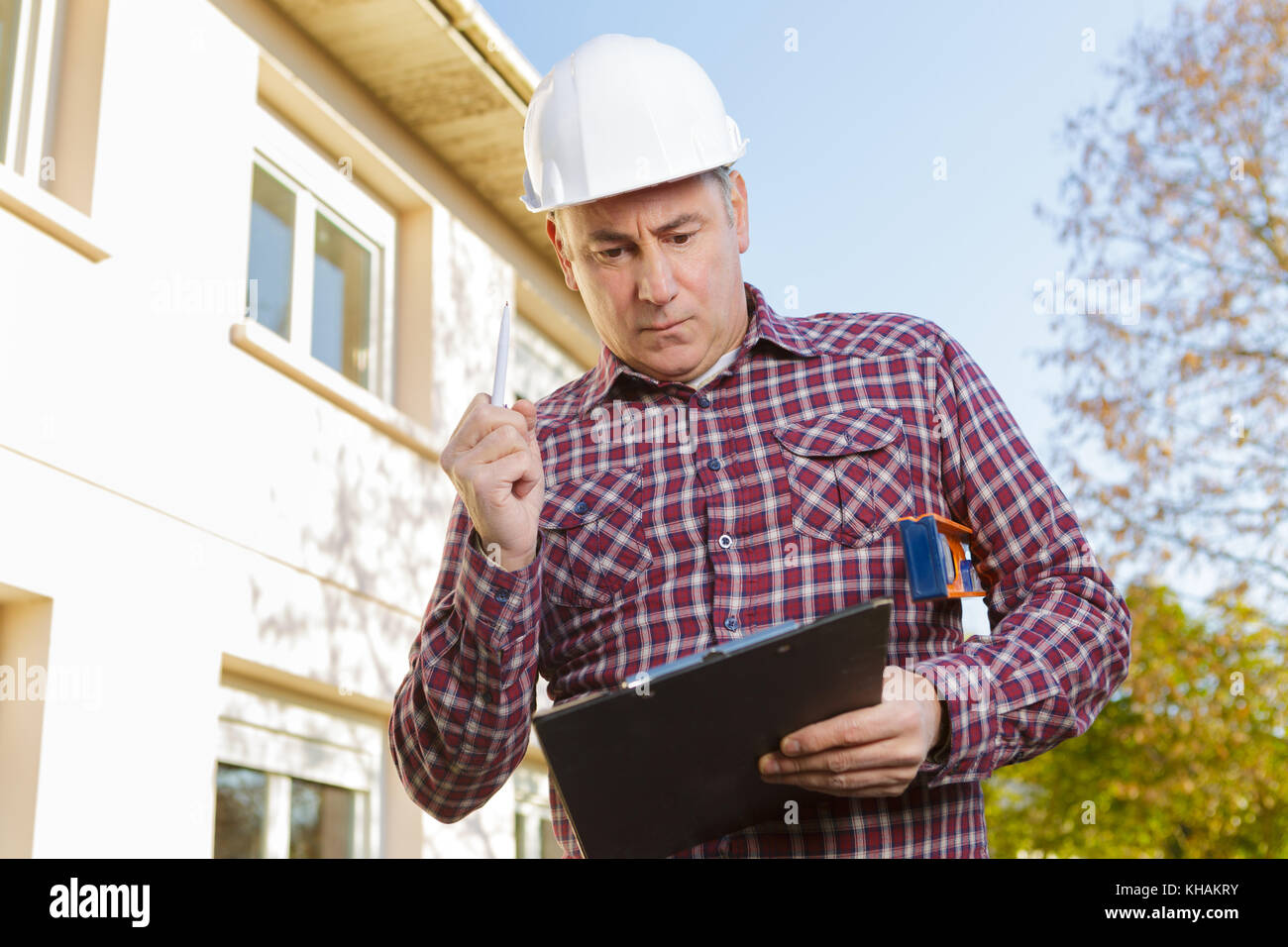 engineer outdoors checking clipboard Stock Photo - Alamy