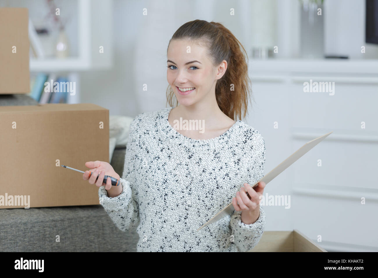 happy woman holding tools at home Stock Photo - Alamy