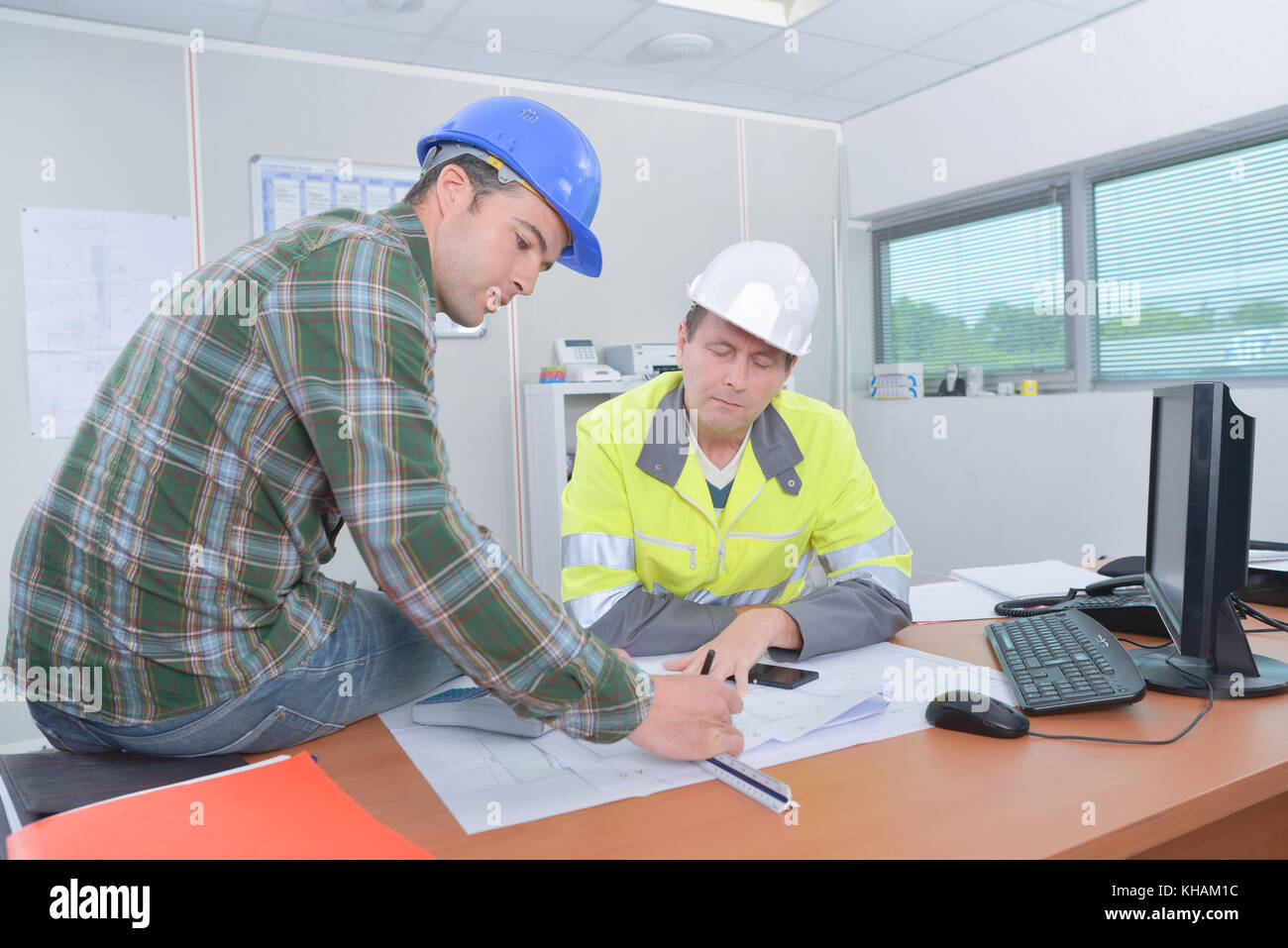 two workmen in office Stock Photo - Alamy