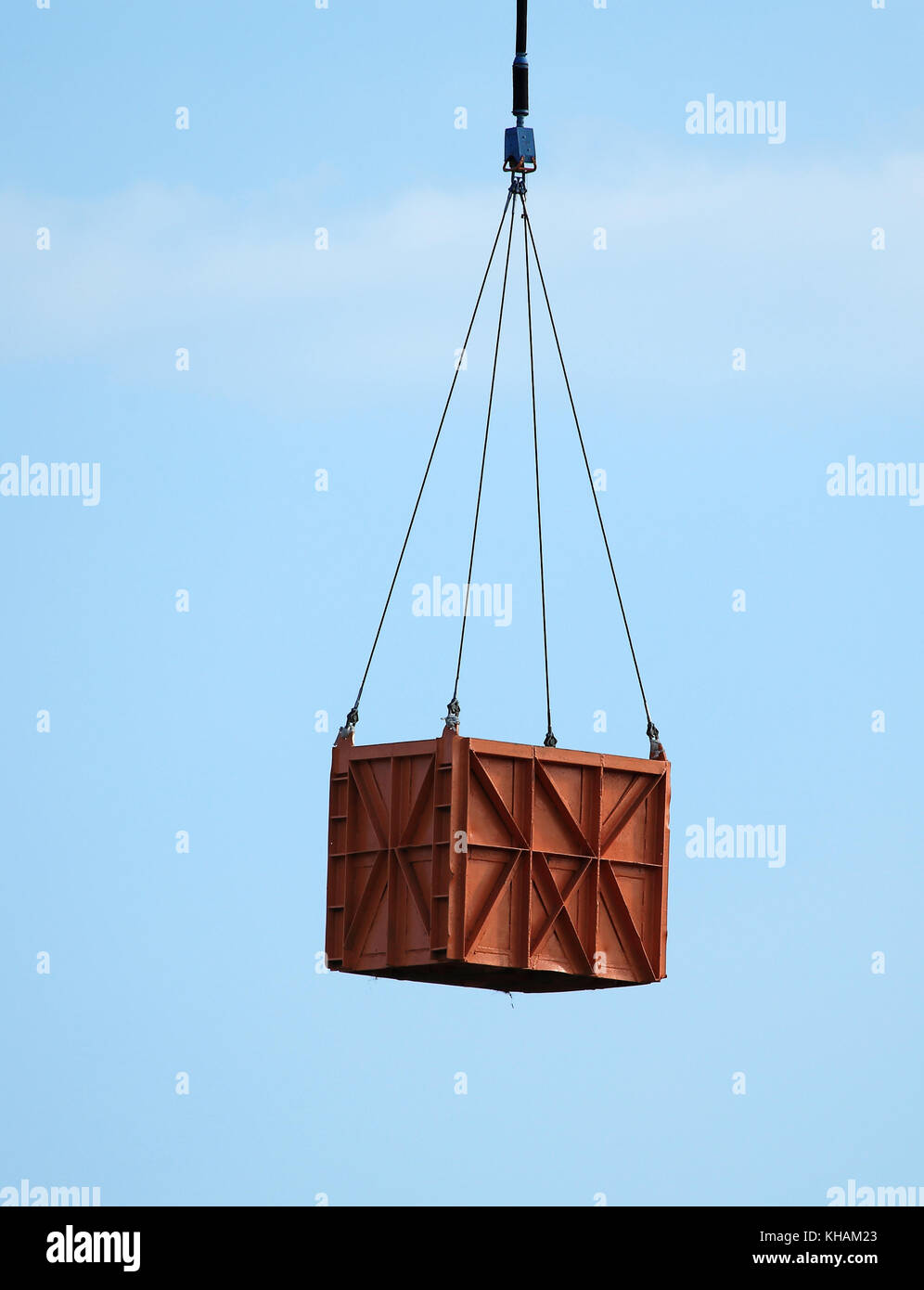 Metal cargo container is attached by cable to the aircraft for ...