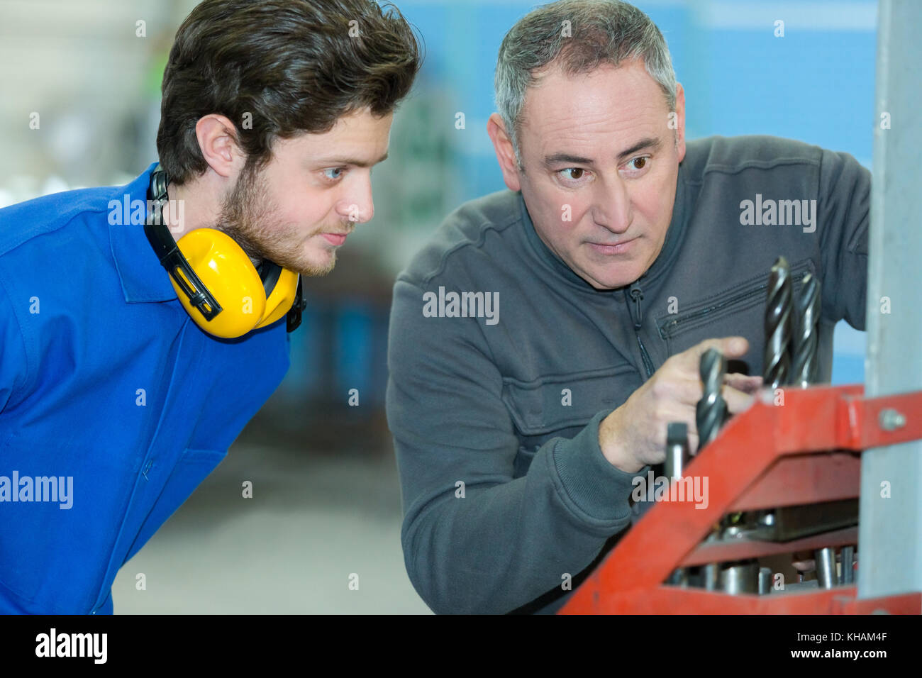 apprentice in workshop factory with teacher Stock Photo - Alamy