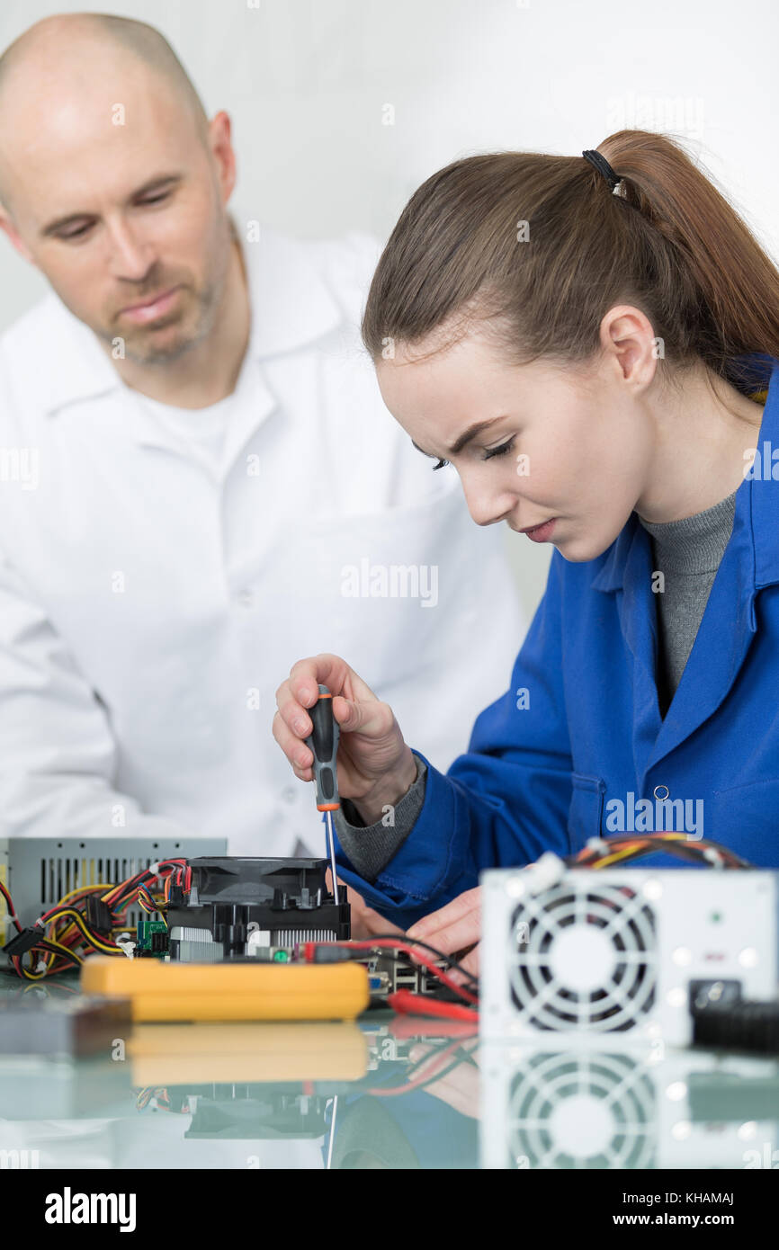 female pc technician soldering a chip from a desktop computer Stock ...
