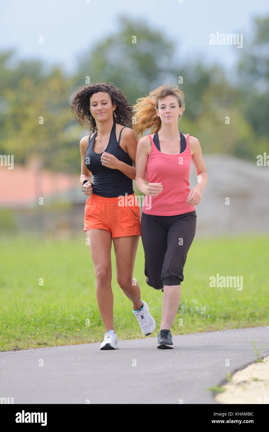 Two women jogging in park Stock Photo - Alamy