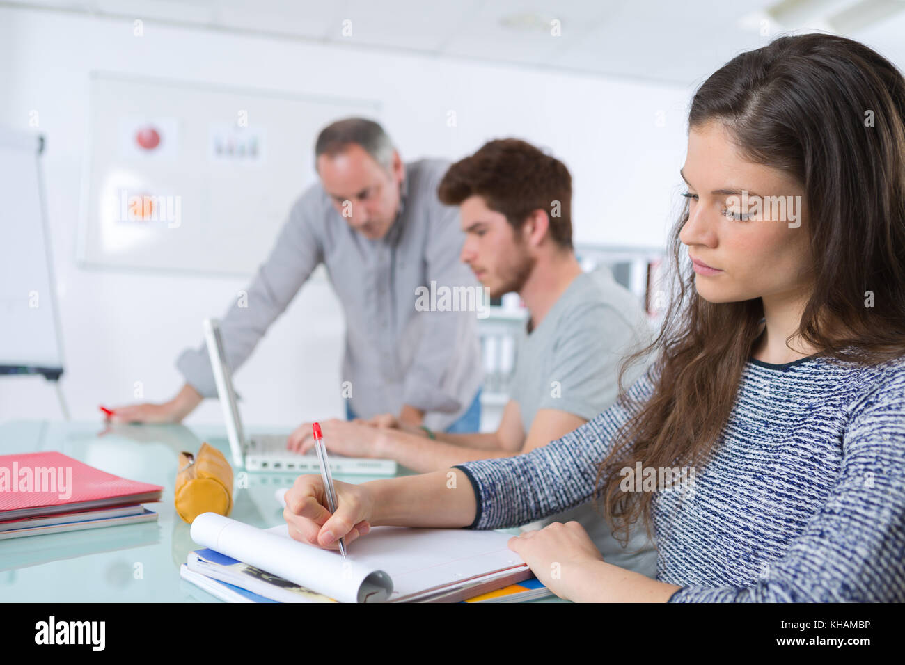 students writing something during class Stock Photo - Alamy