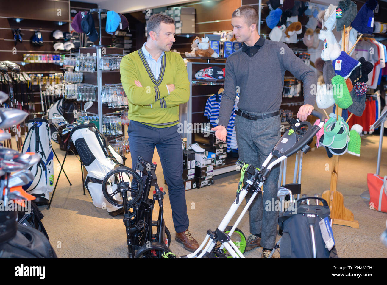 male seller and customer in golf store Stock Photo - Alamy