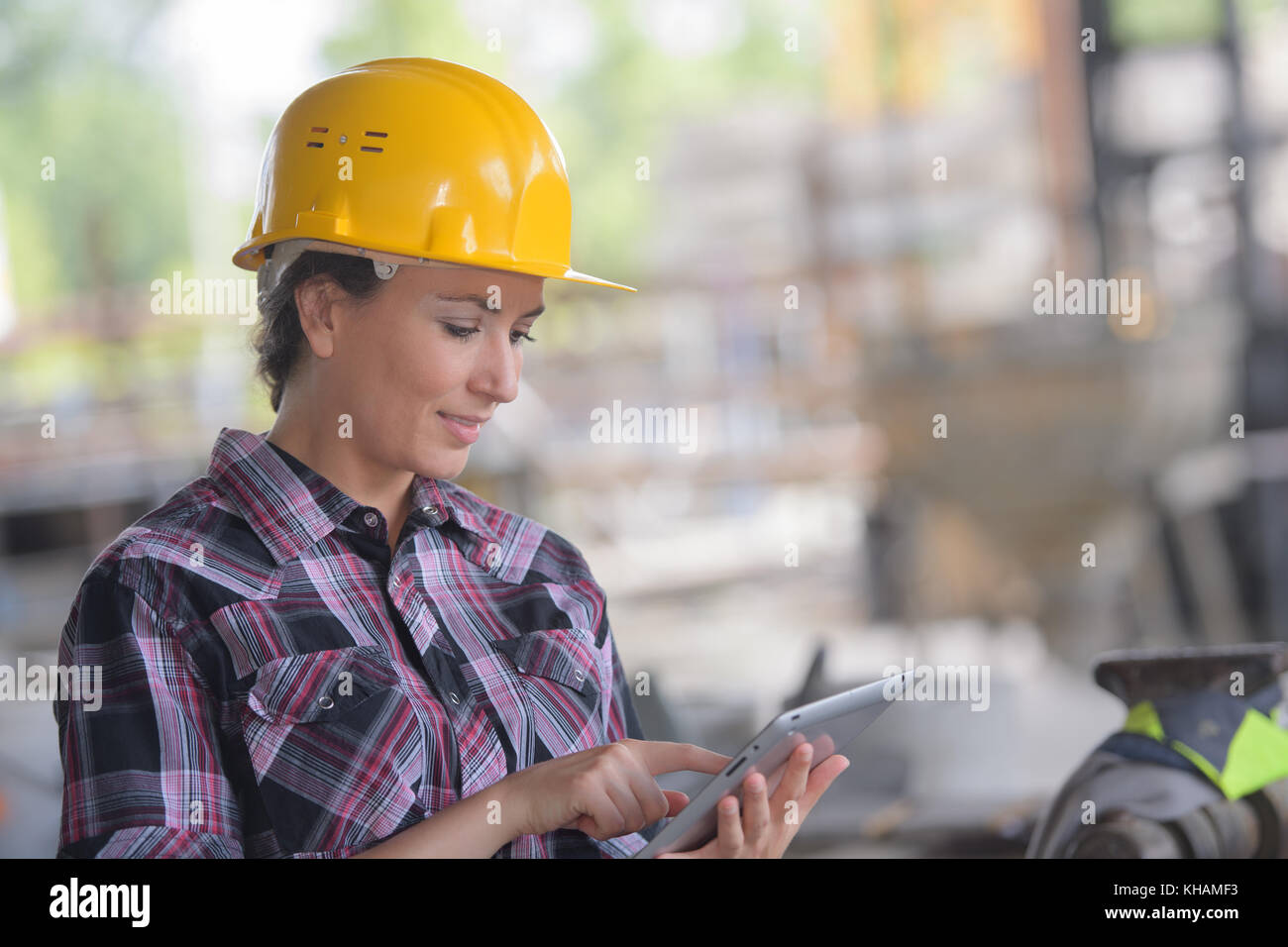 female engineer working in temperature control room of large building ...