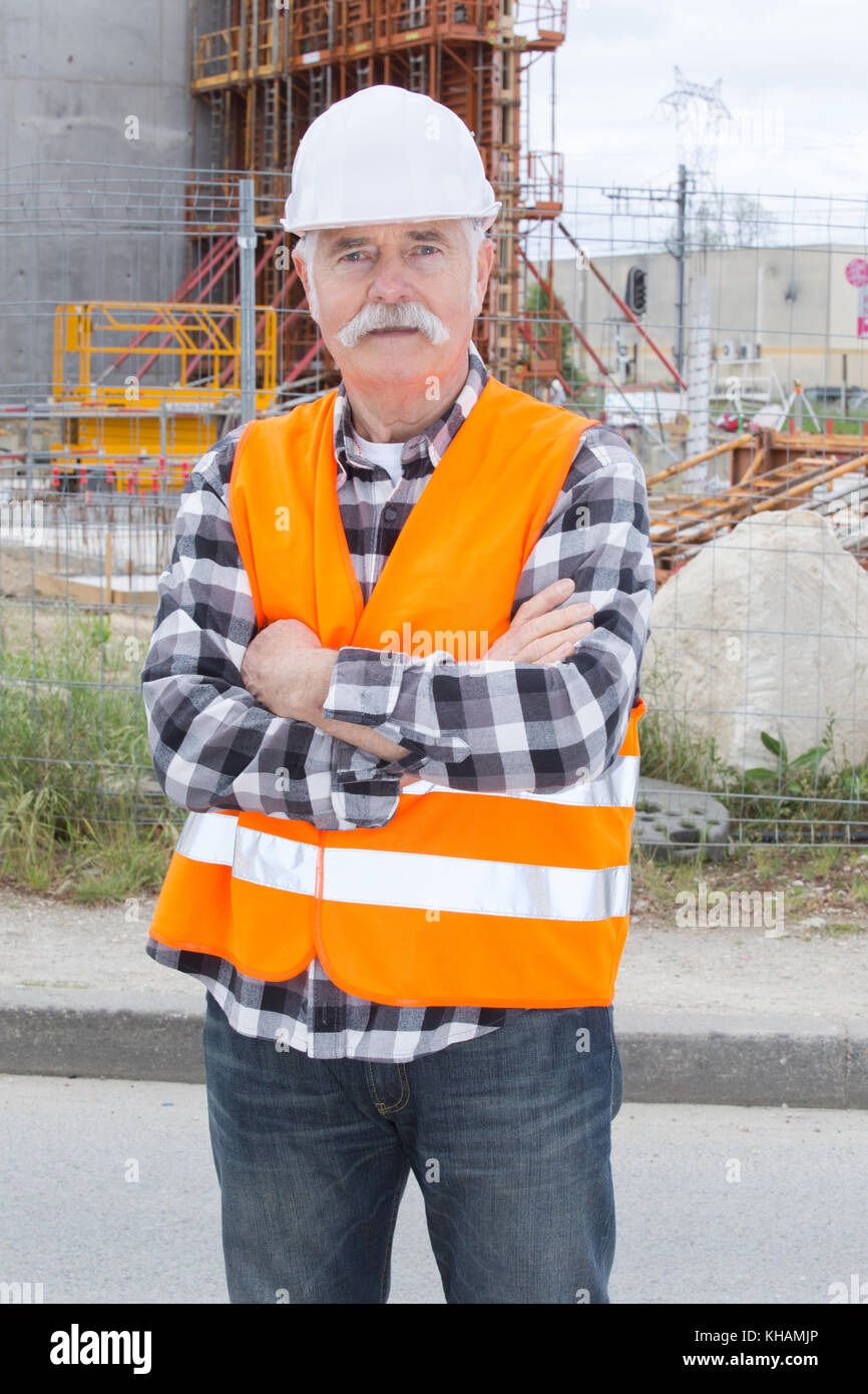 happy senior construction worker smiling with arms crossed Stock Photo ...