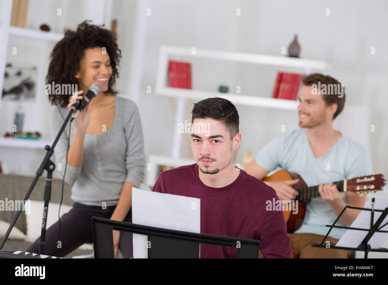 friends having fun at home singing a song together Stock Photo - Alamy