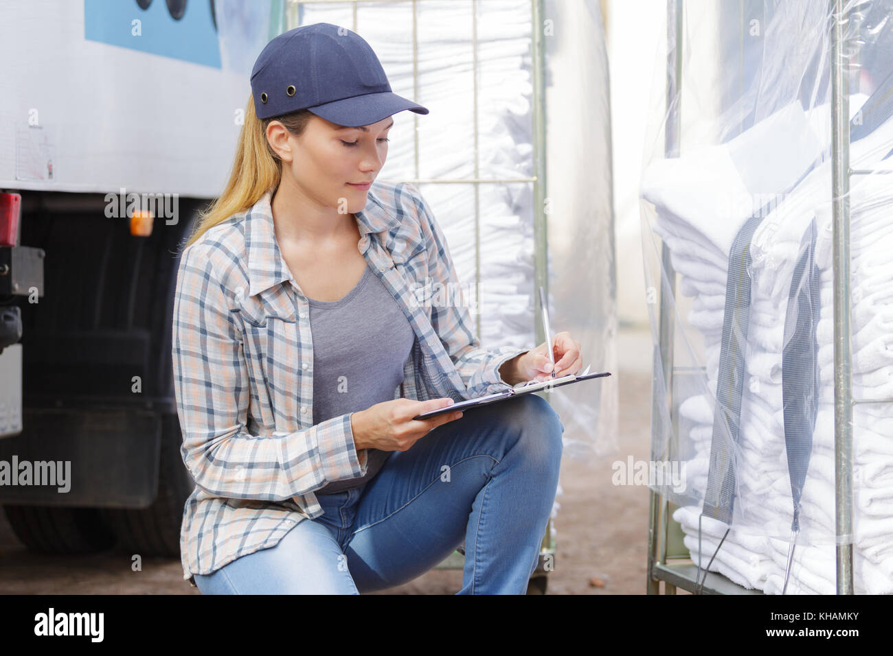 woman listing the clean laundry to be deliver Stock Photo - Alamy