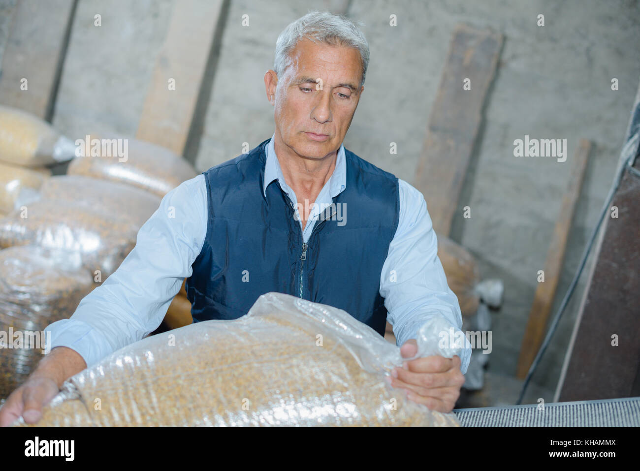 Man moving bag of seeds Stock Photo - Alamy