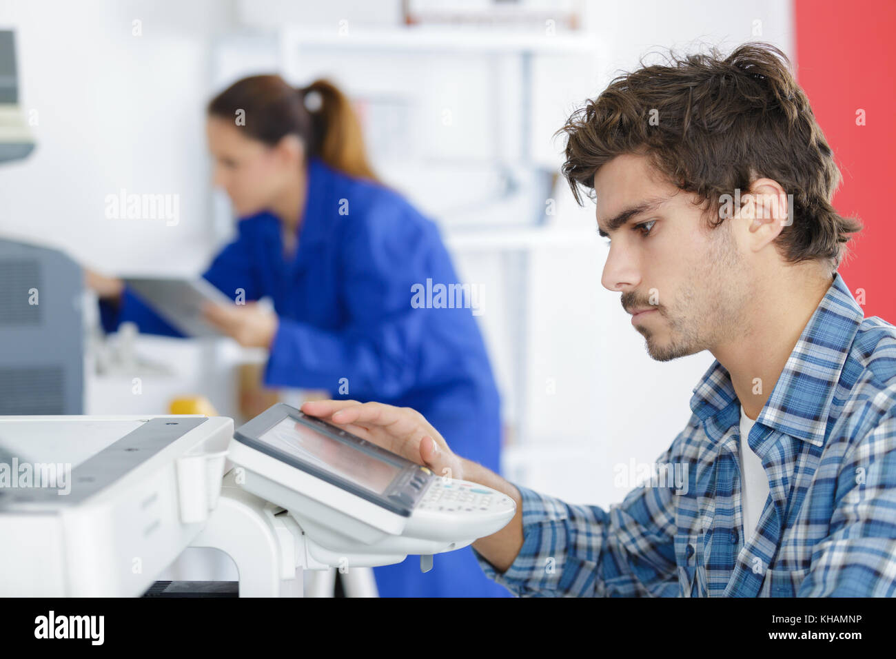 young male technician repairing digital photocopier machine Stock Photo ...
