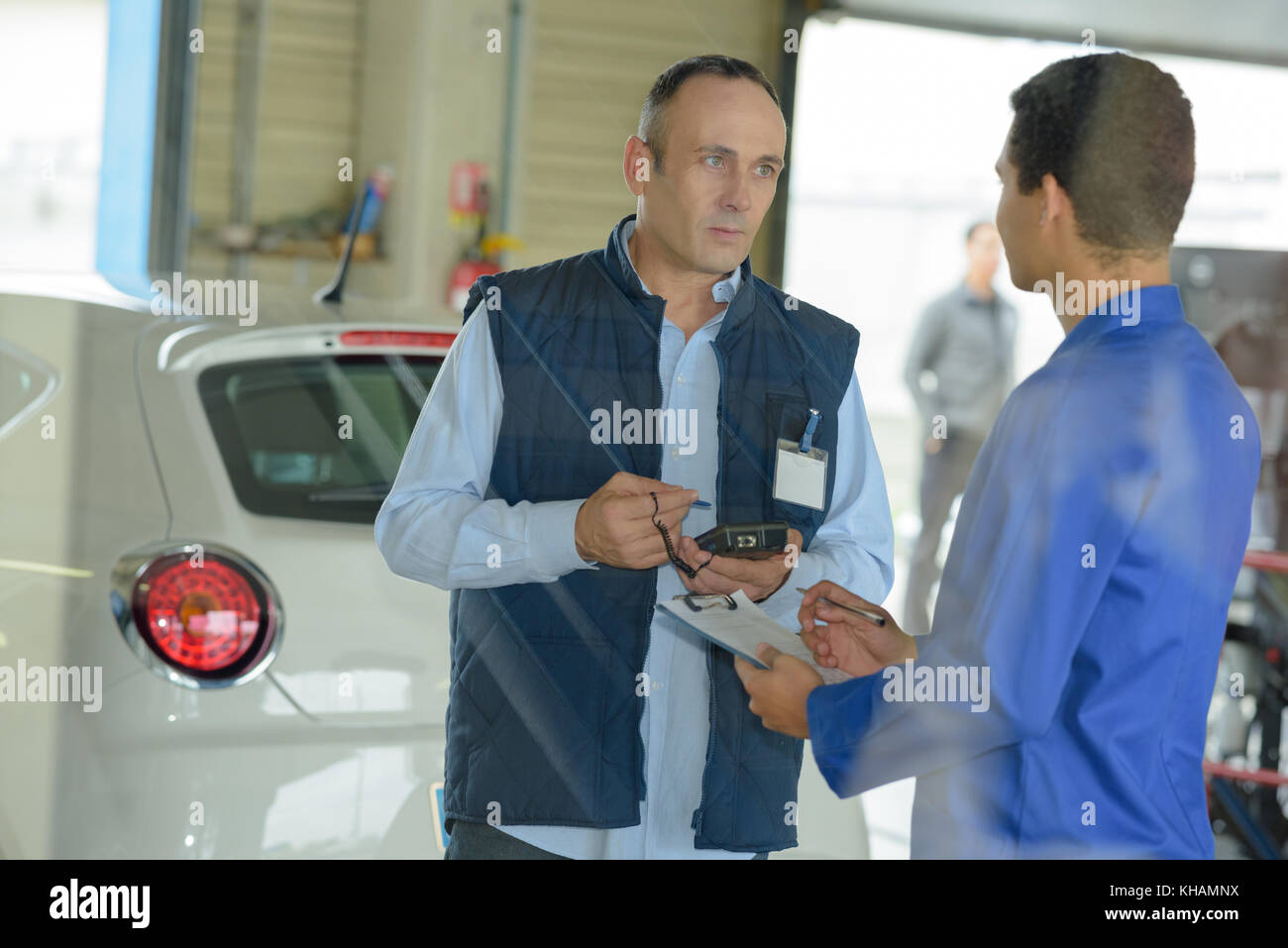 in the factory- boss and worker on work bench Stock Photo - Alamy