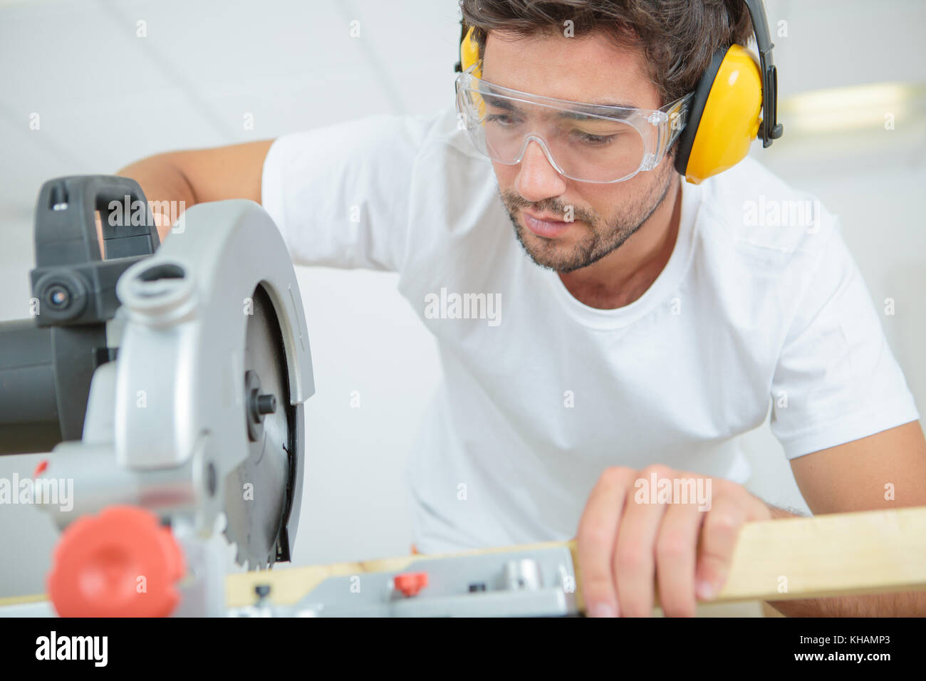 Man sawing wood Stock Photo - Alamy