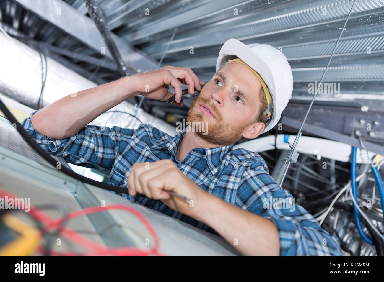 young handsome electrician on the phone Stock Photo - Alamy