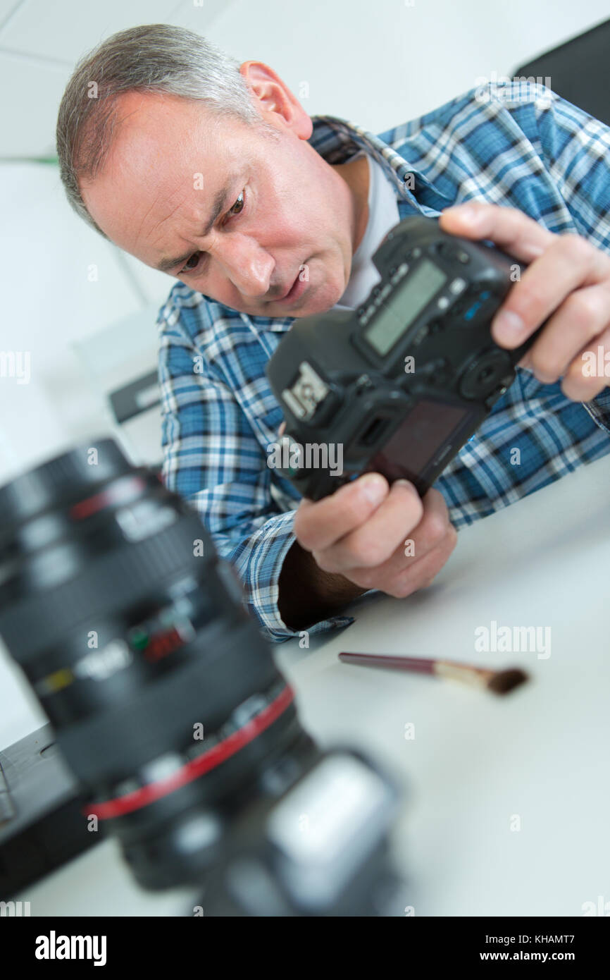 man fixing camera Stock Photo - Alamy