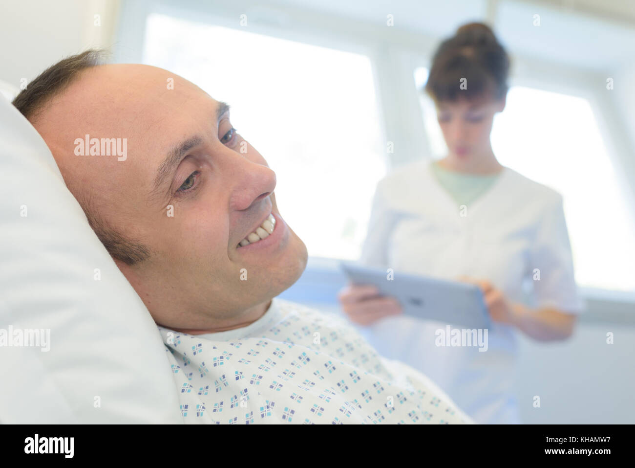happy patient lying on hospital bed Stock Photo - Alamy