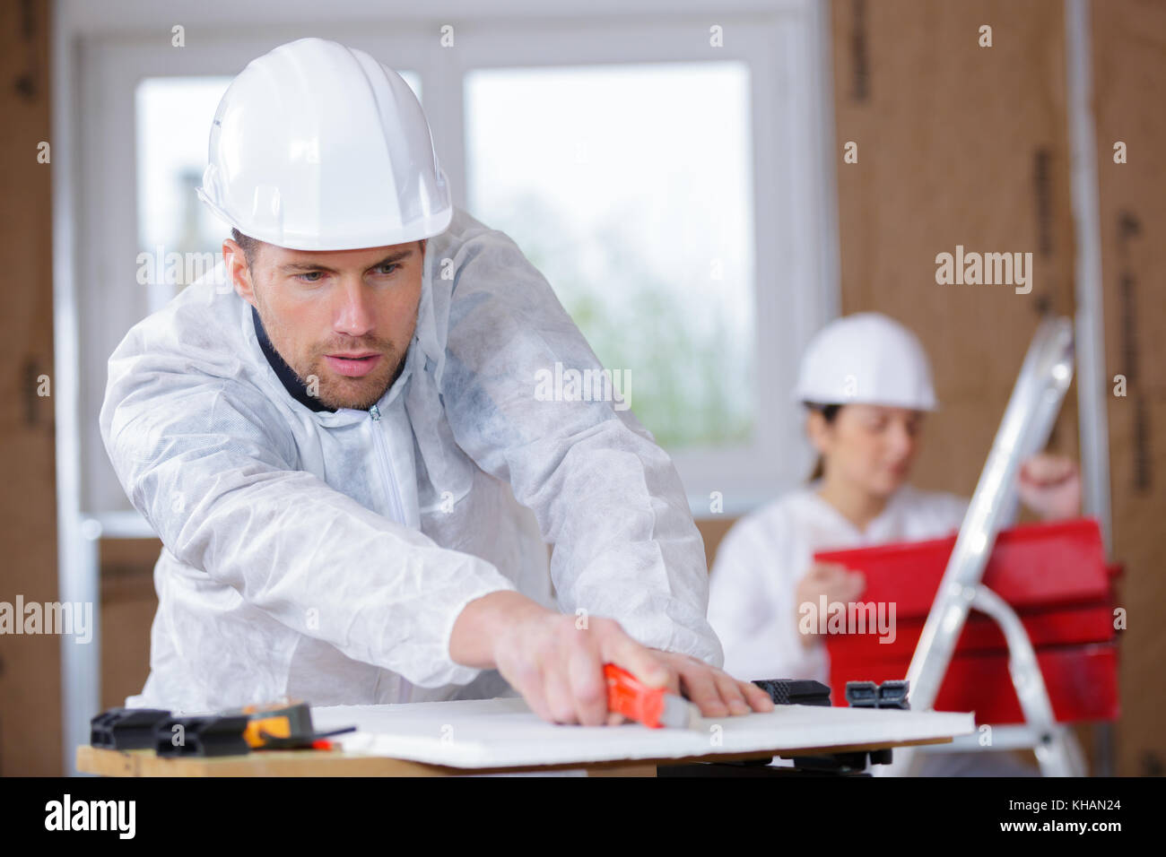 worker builder cutting material Stock Photo - Alamy