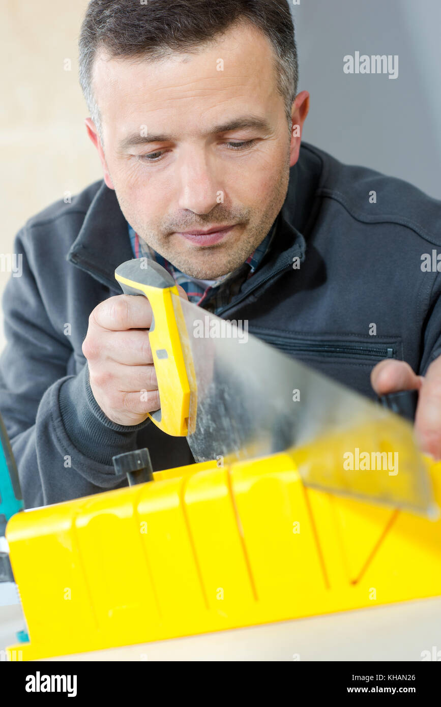 Man using hand saw Stock Photo - Alamy