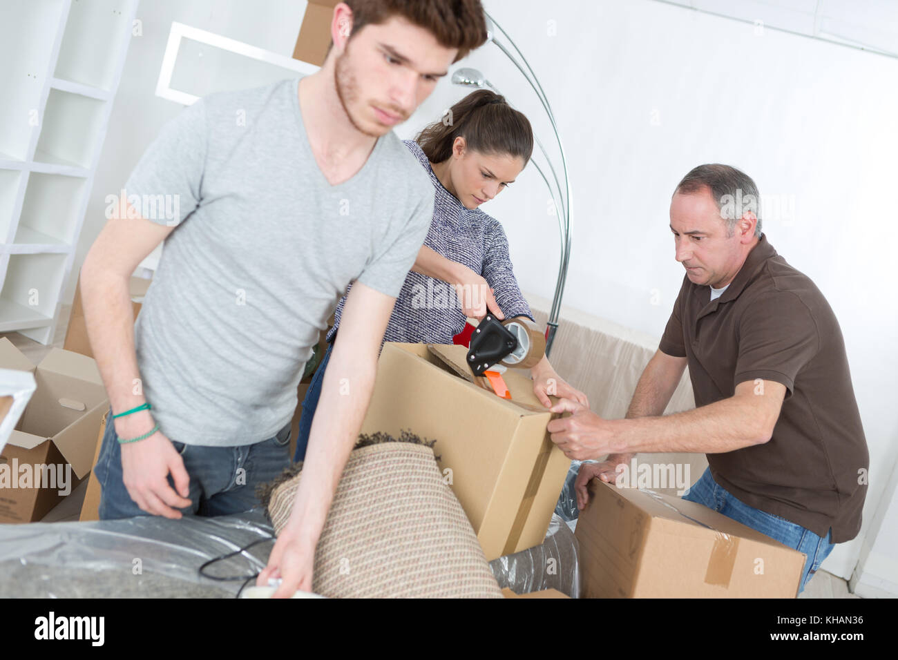 family packing cardboard boxes Stock Photo - Alamy