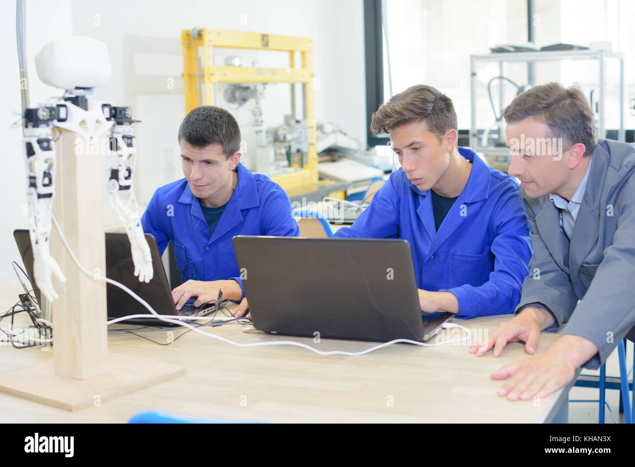 Teacher with robotics students Stock Photo - Alamy