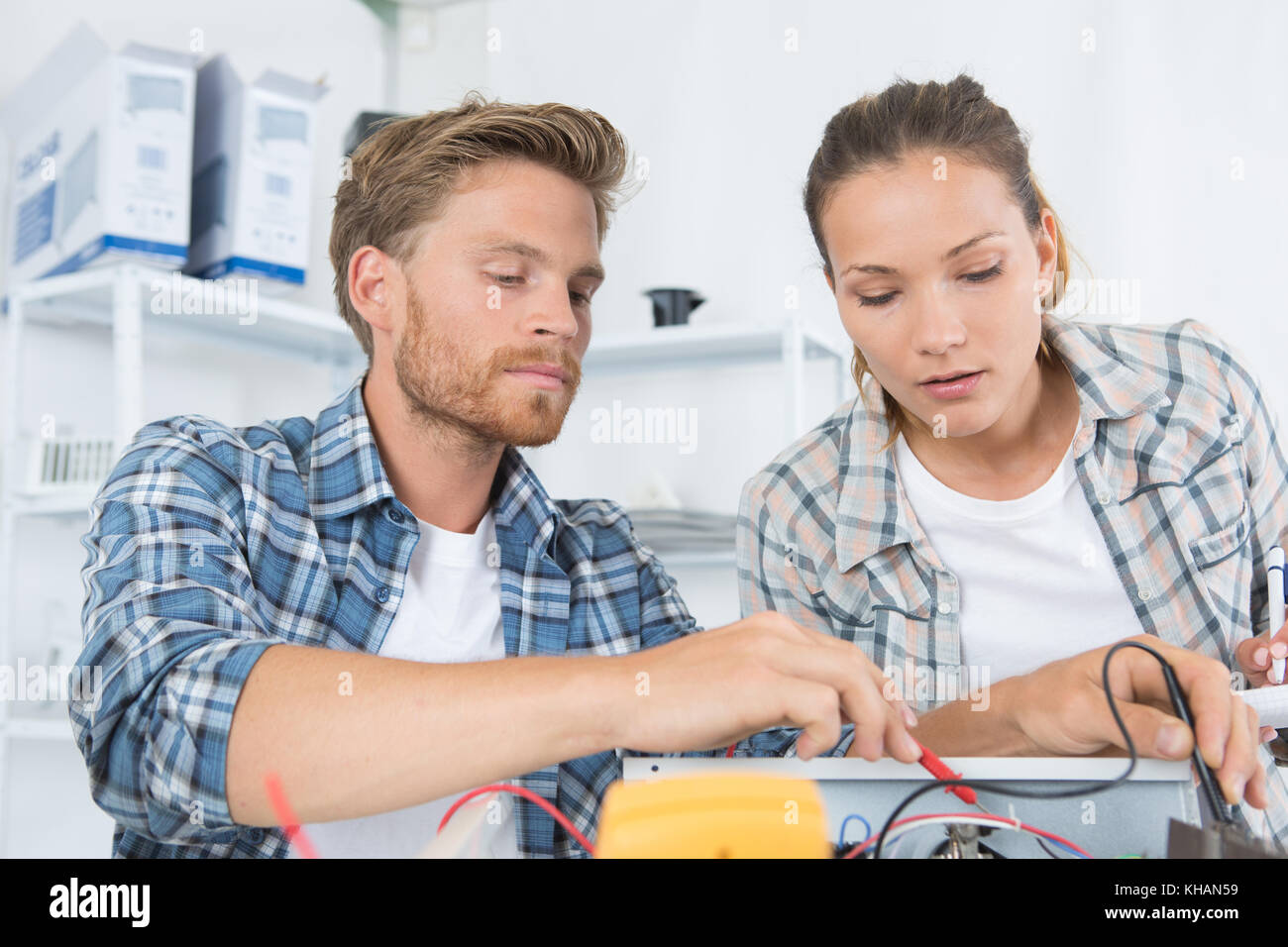 two workers holding multimeter checking voltage Stock Photo - Alamy