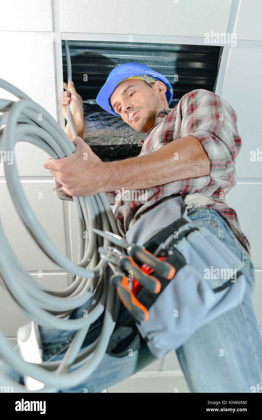 Construction worker placing hoses Stock Photo - Alamy