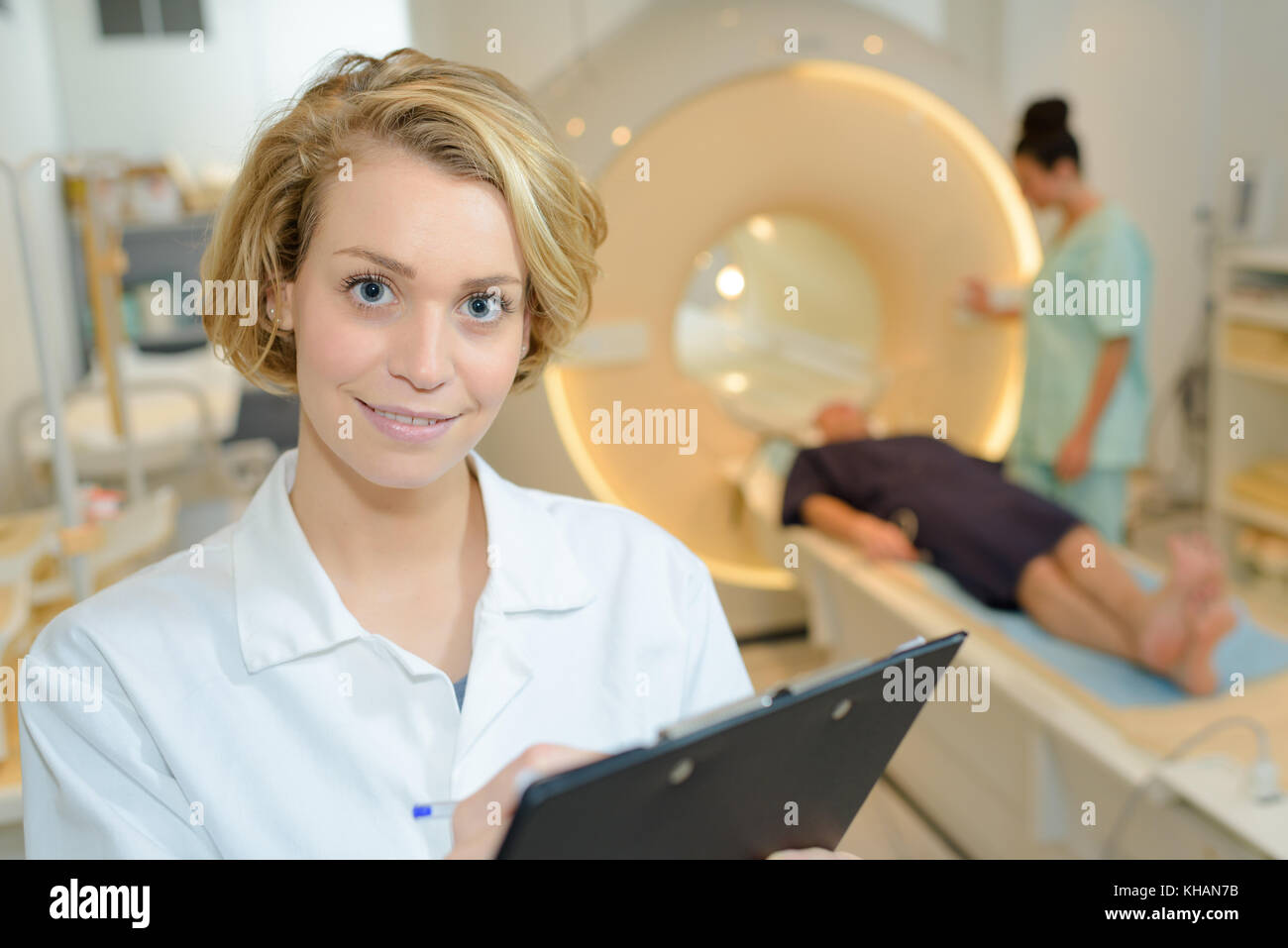 smiling female professional against mri machine in hospital Stock Photo ...