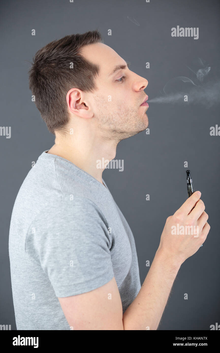 men vaping and releases a cloud of vapor Stock Photo - Alamy