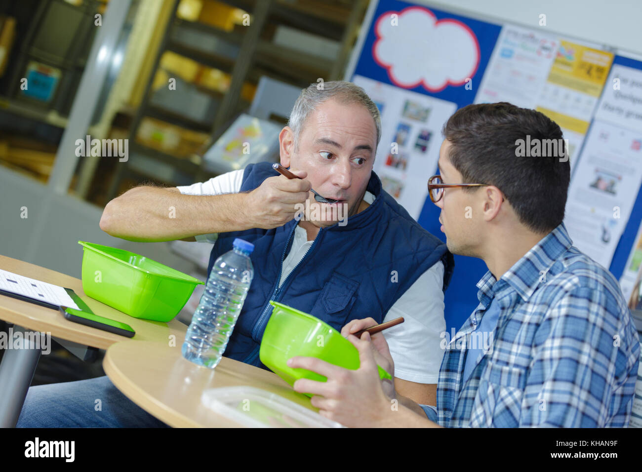 two worker in factory having a lunch break Stock Photo - Alamy