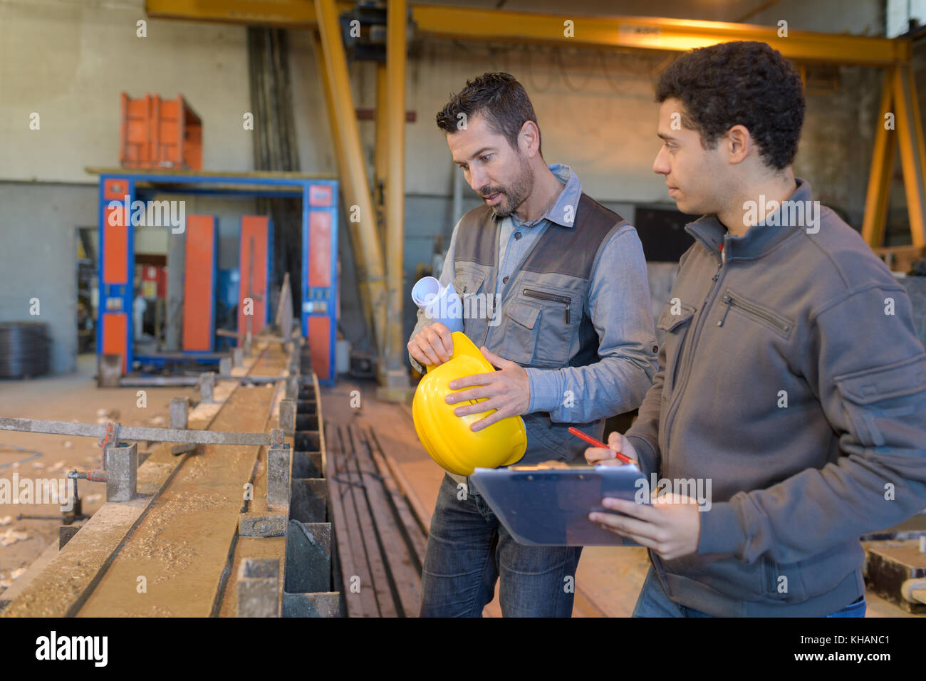 worker and foreman performing quality check on a factory Stock Photo ...