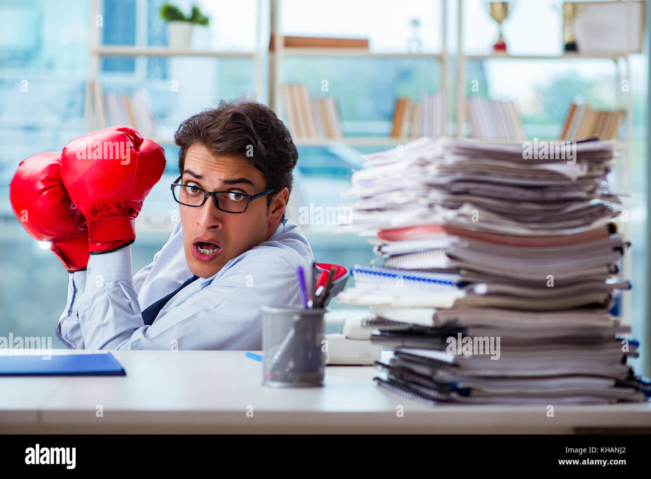 Businessman with boxing gloves in the office Stock Photo - Alamy