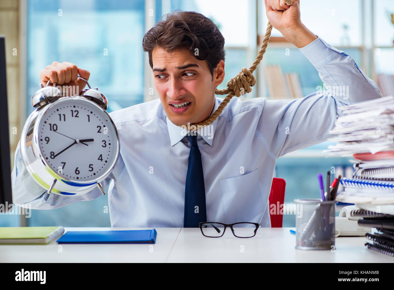 Unhappy businessman thinking of hanging himself in the office Stock ...