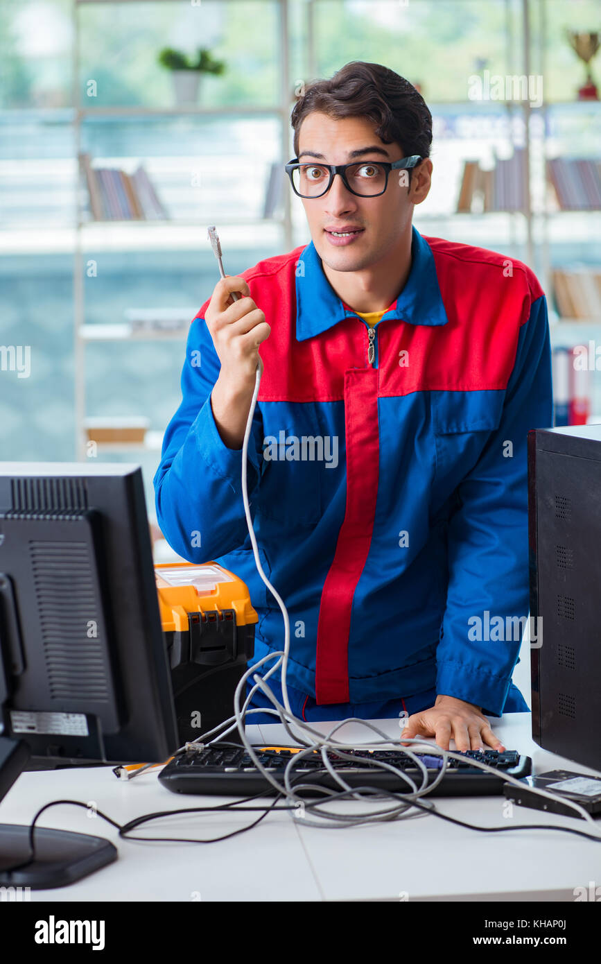 Computer repairman working on repairing computer in IT workshop Stock ...