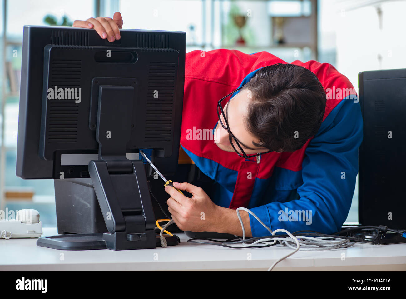 Computer repairman working on repairing computer in IT workshop Stock ...