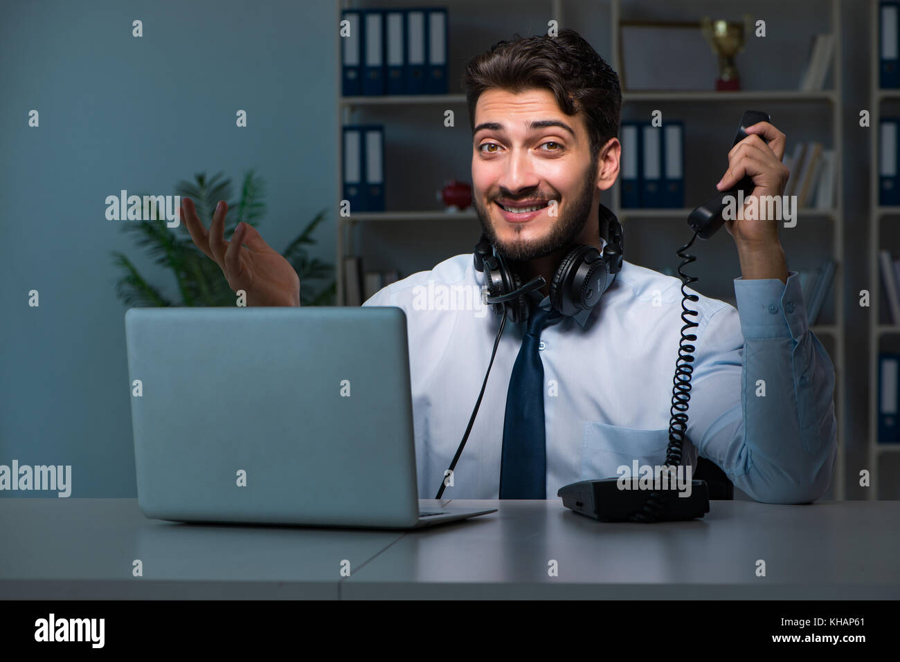 Young man in call center concept working late overtime in office Stock ...