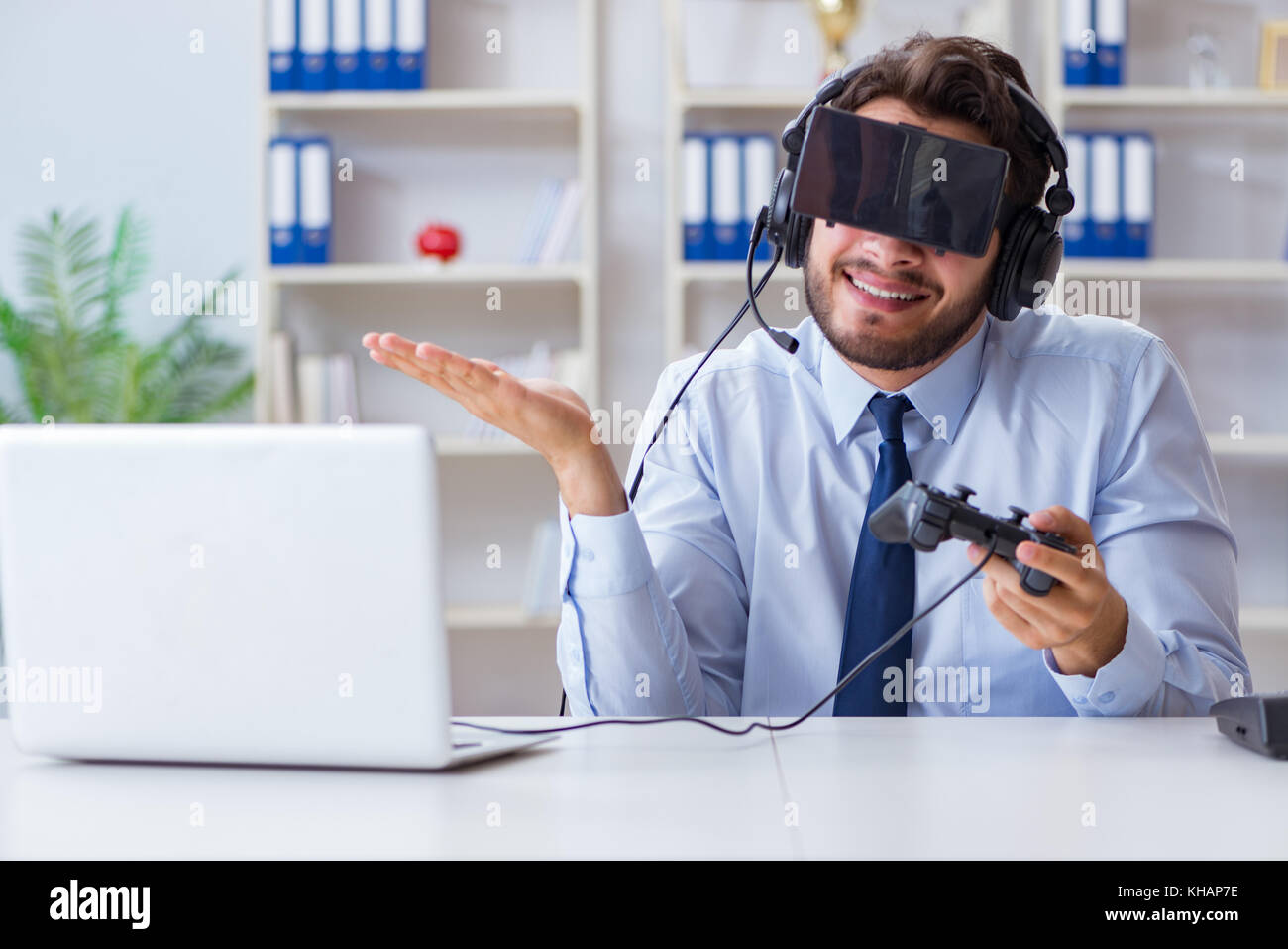 Businessman gamer in office playing games Stock Photo - Alamy