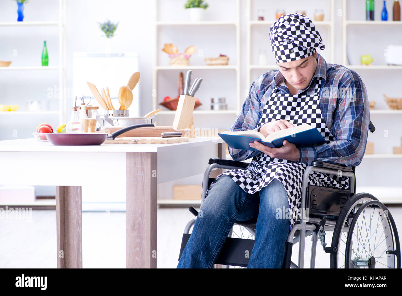 Young man cook with book of food recipes Stock Photo - Alamy